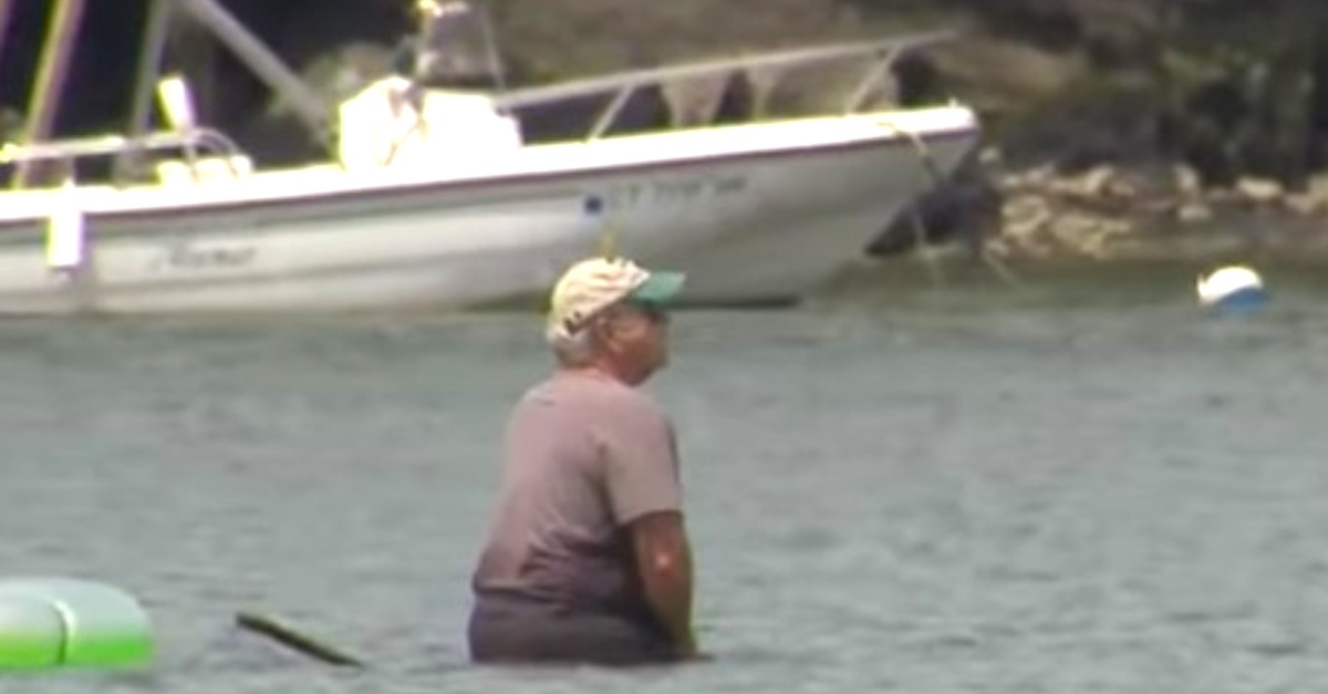 He Walks Waist-Deep Into The Water. Now Watch When He Lifts His Arms Up...
