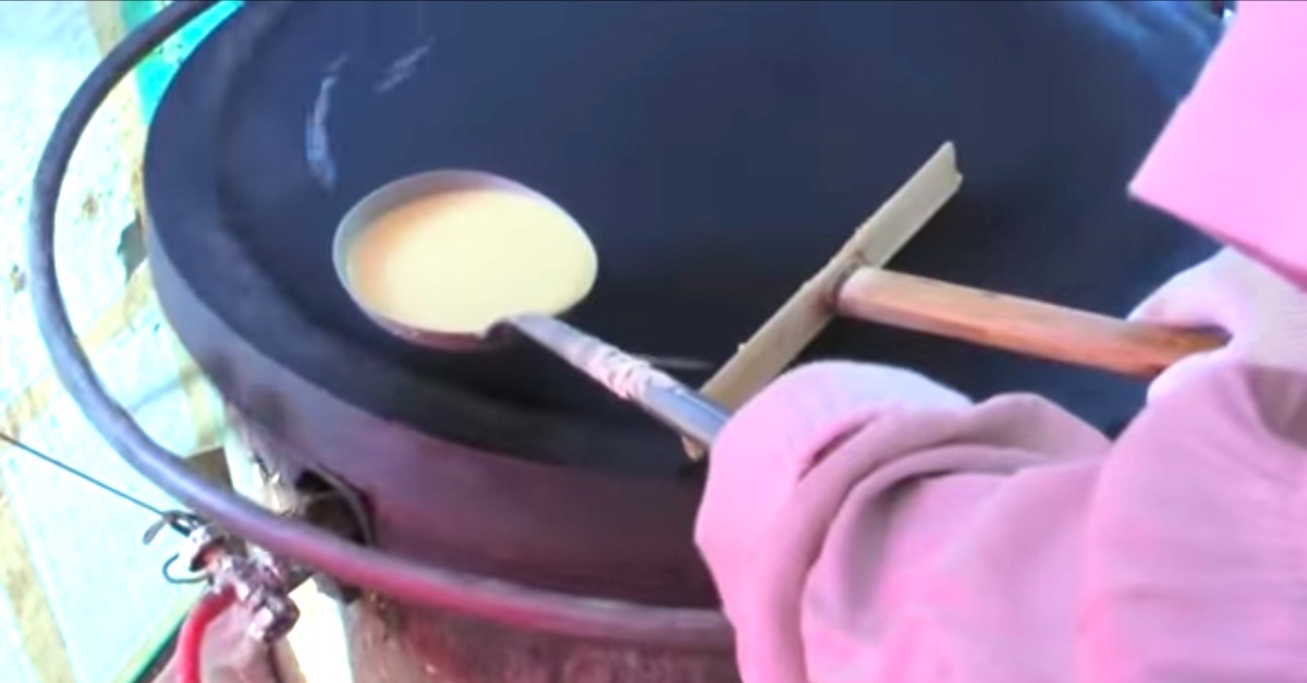 He Holds A Ladle Over A Giant Spinning Black Wheel. Watch When It ...
