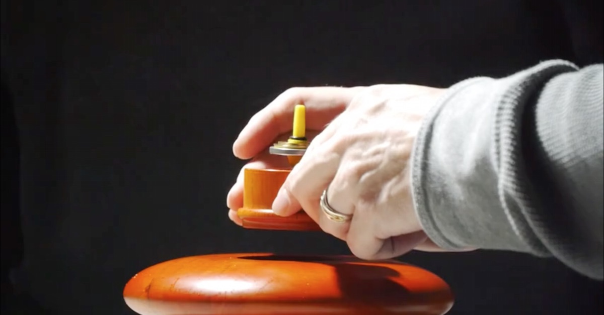 He Lifts Up A Spinning Top, But When He Takes The Wooden Base Away ...